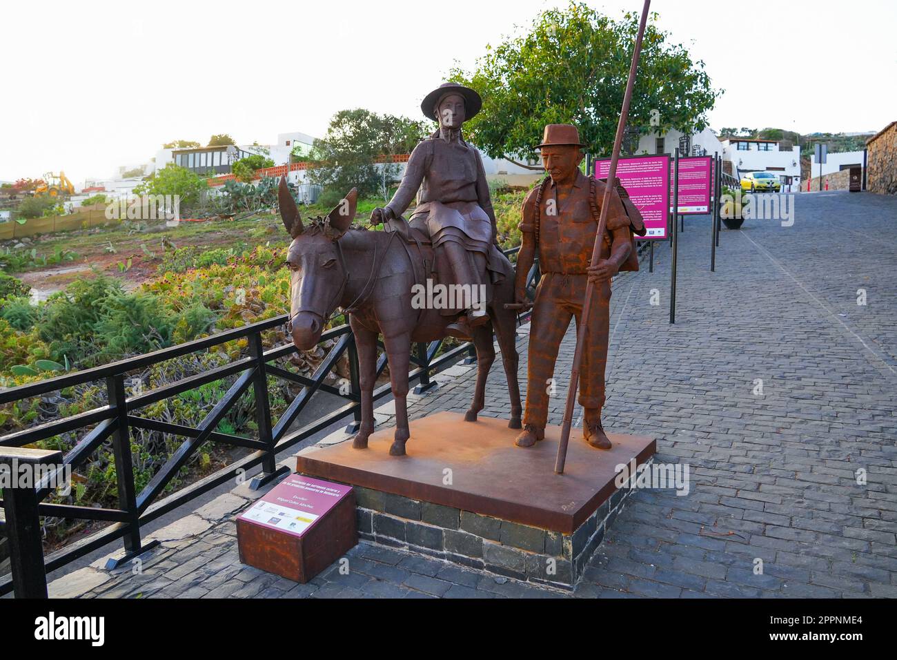 Statue of an old couple with a lady riding a donkey and a man walking ...