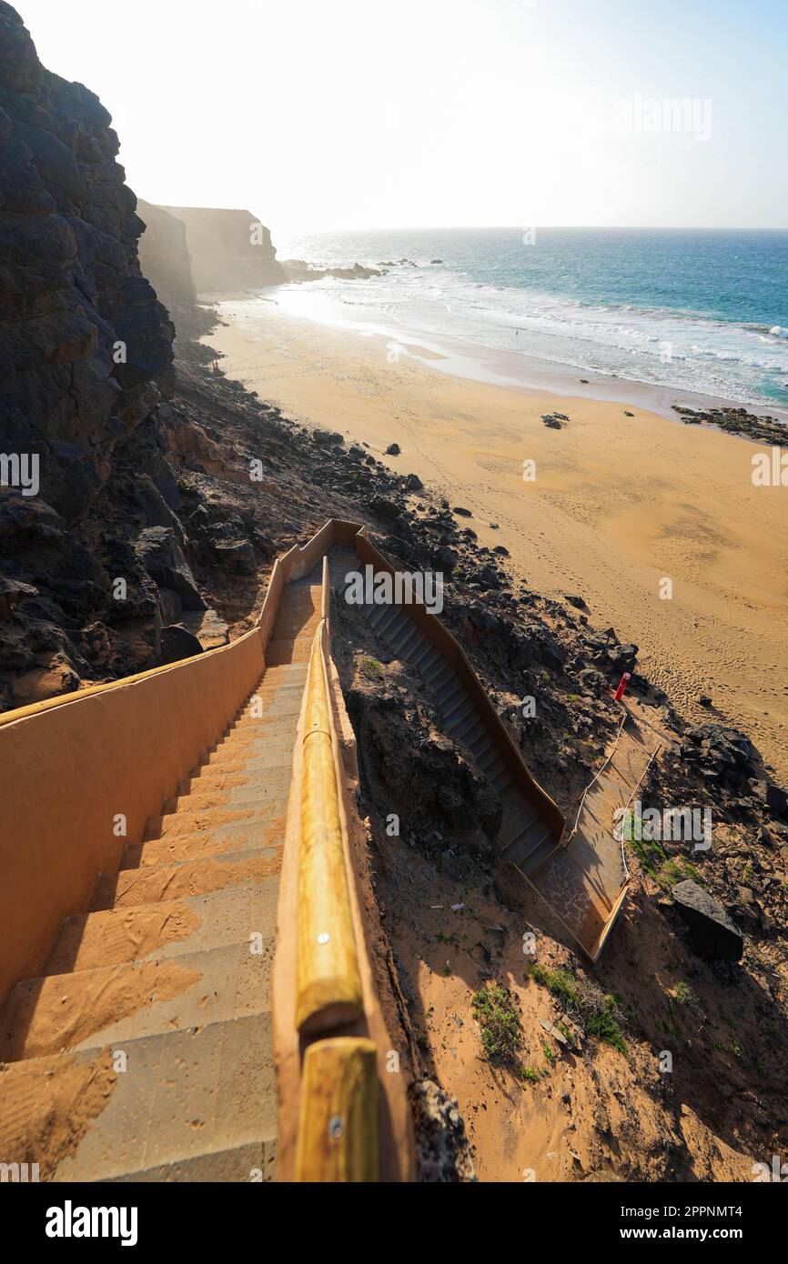 Concrete stairs built on a cliff descending to the Playa de la Escalera ...