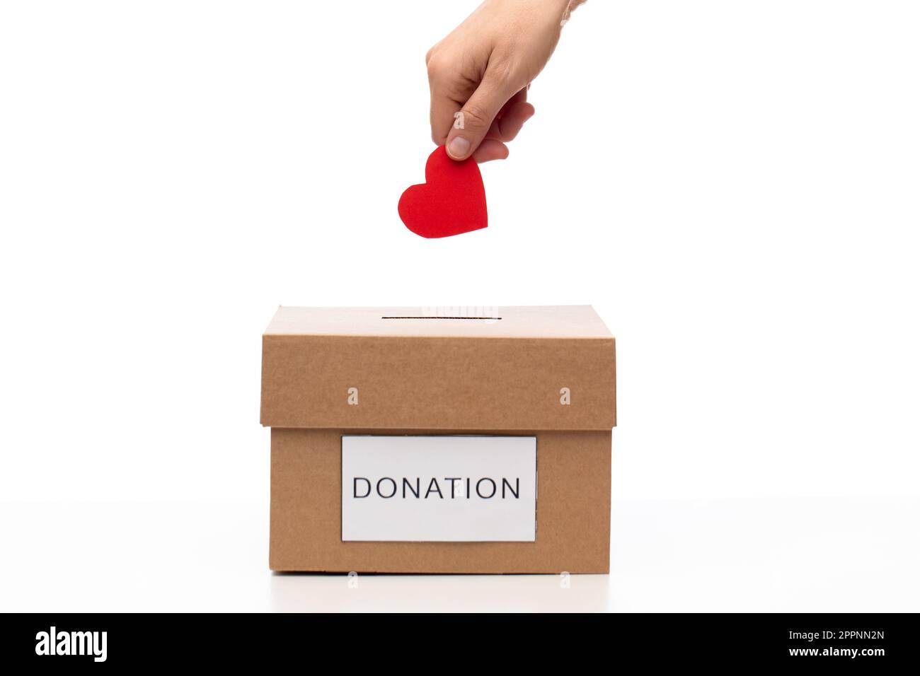 hand putting red heart into charity donation box Stock Photo - Alamy