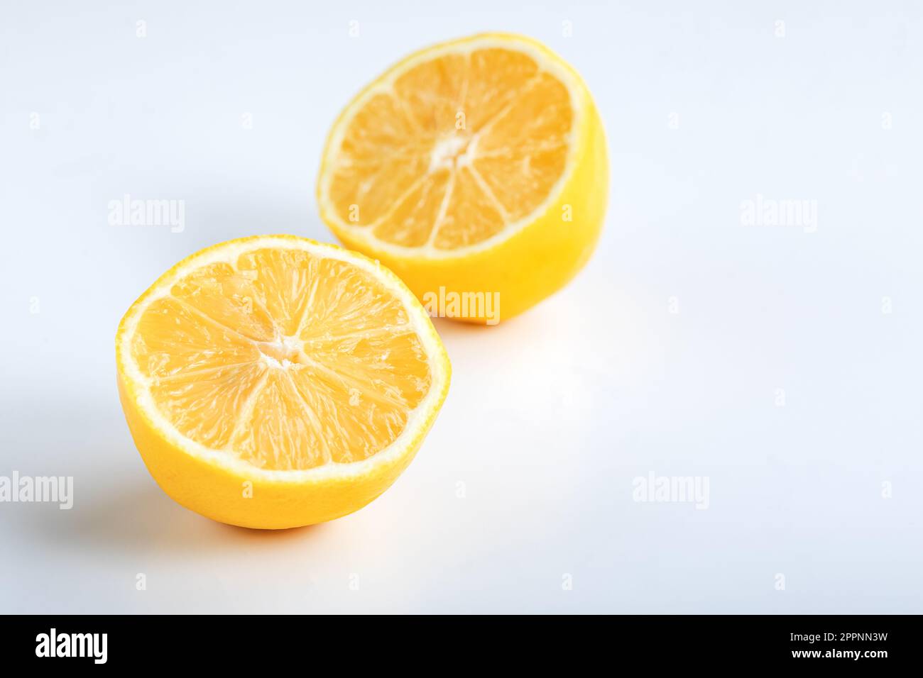 Lemon fruit cut in half, isolated on white background. Lemon cut in ...