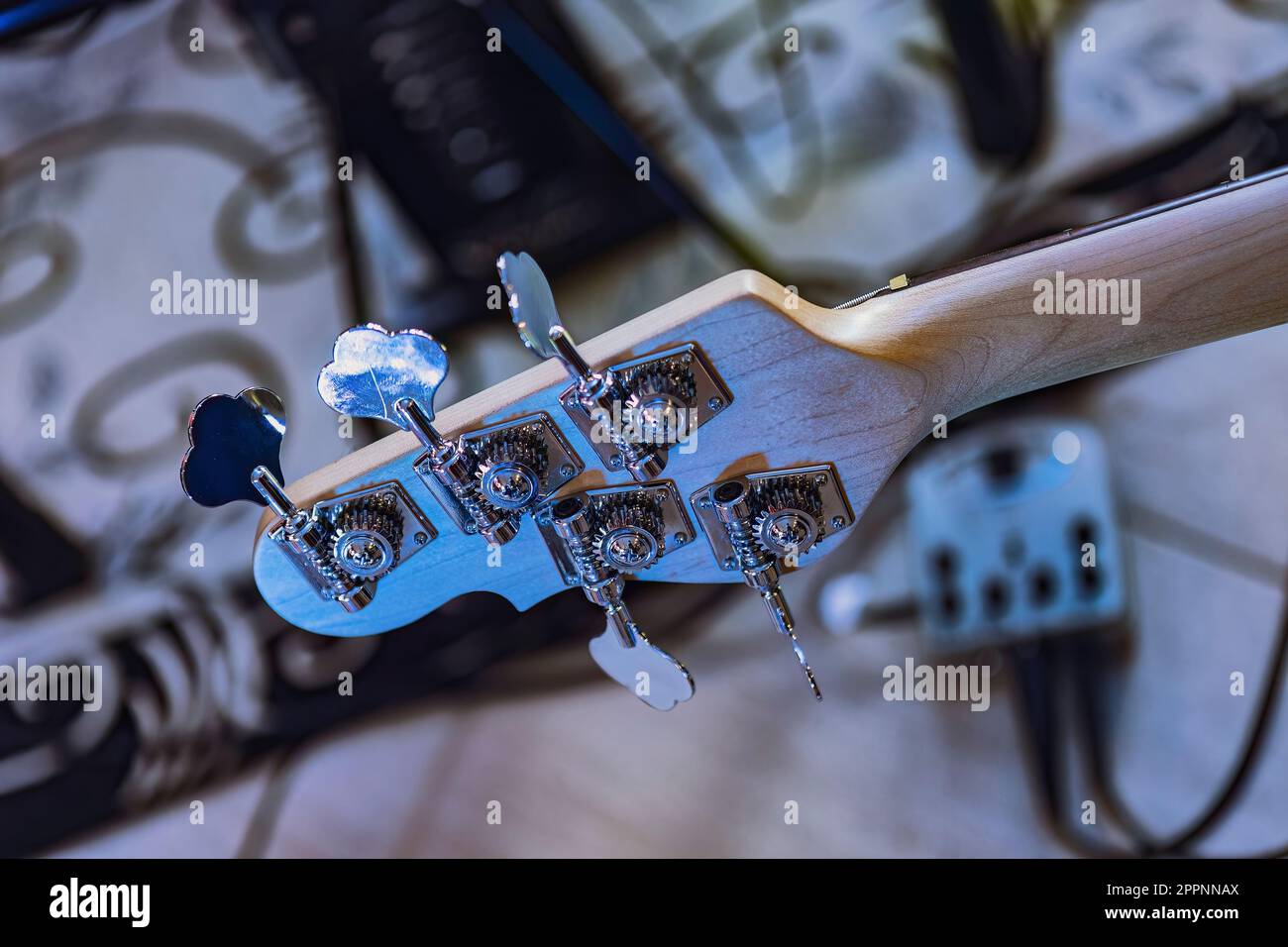 A close-up photo of a black bass guitar pick on a white background ...