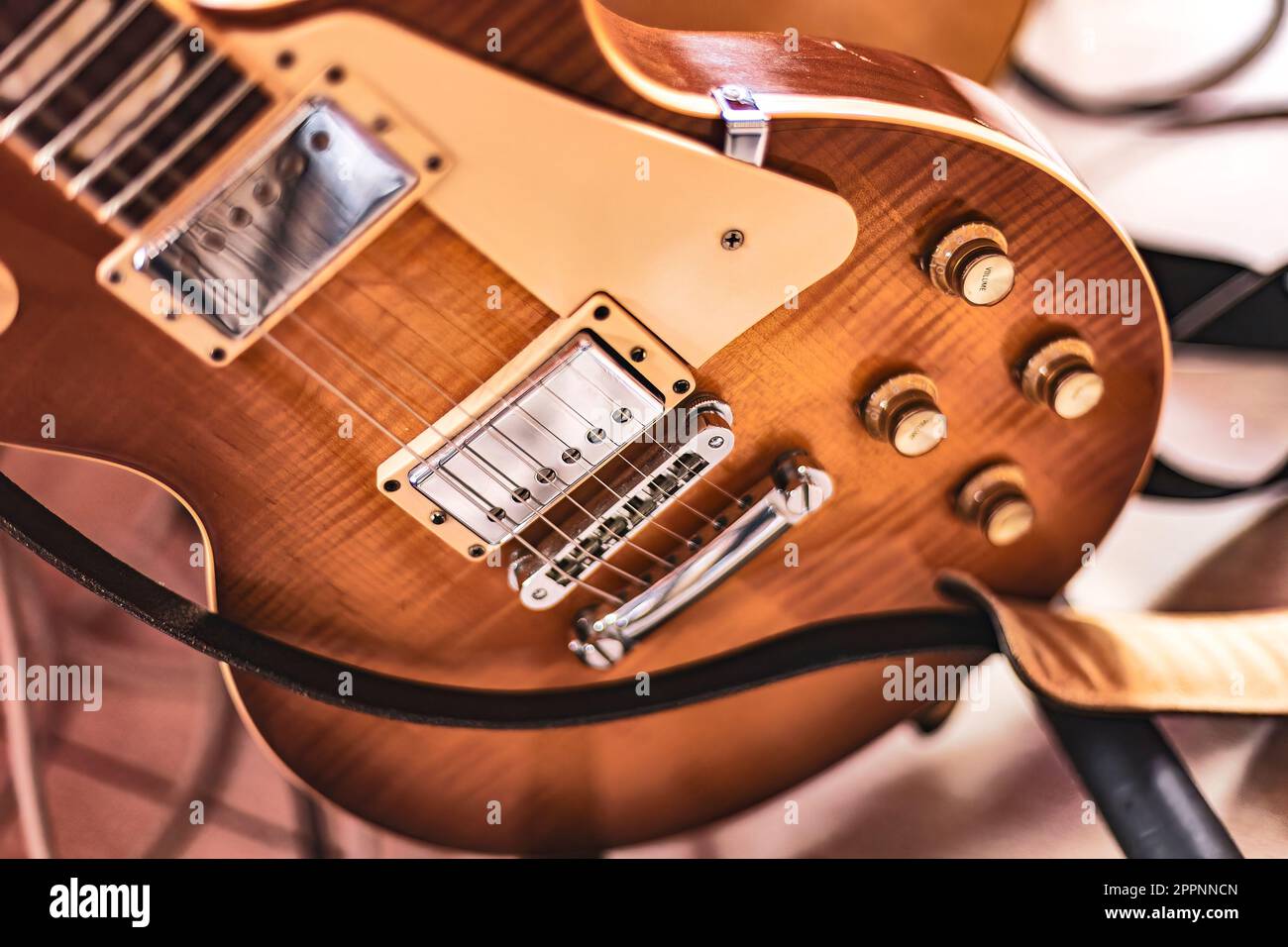 A close-up photo of multiple electric guitars in a row, showing their ...