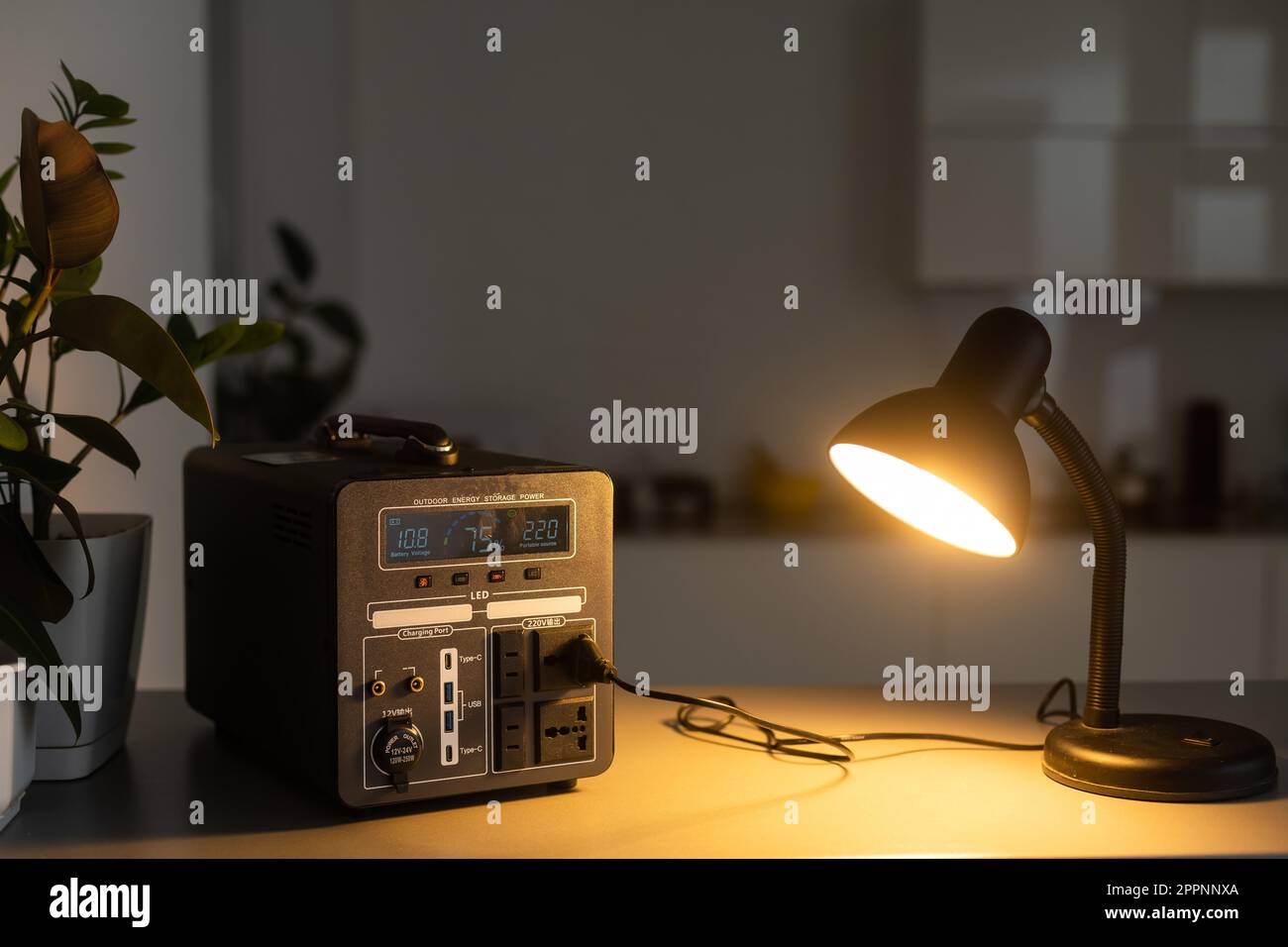 Portable power station charging tablet computer on table in living room ...