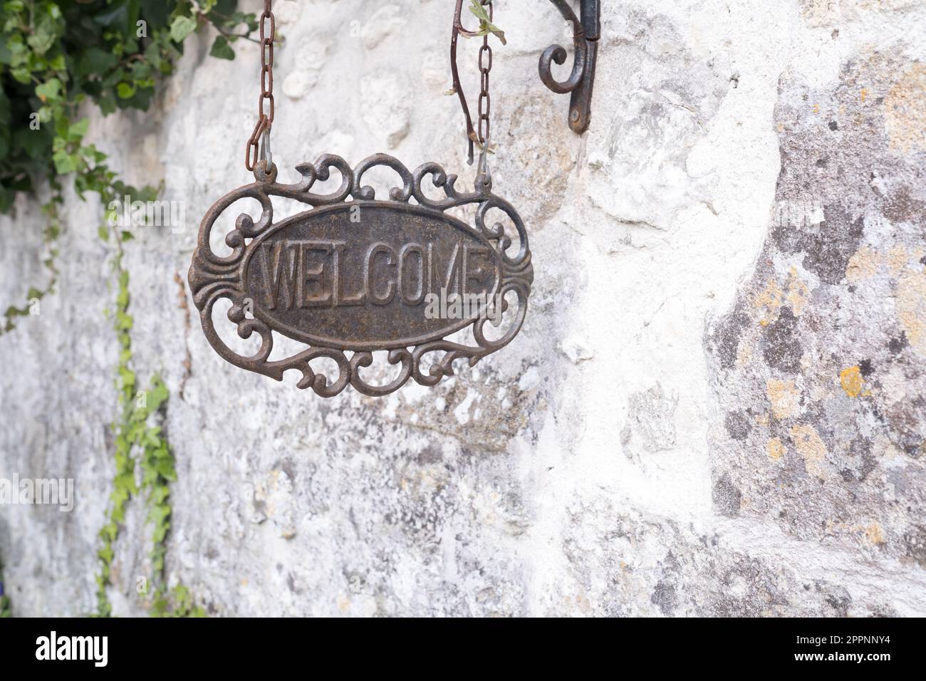 Decorative brass welcome sign Stock Photo - Alamy