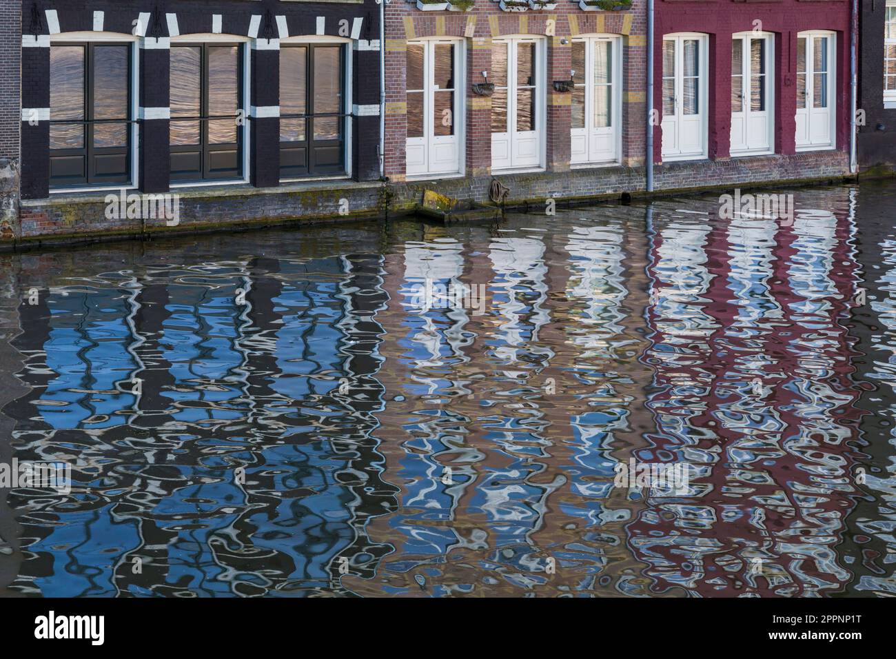 Dancing houses, buildings with reflections in windows by Damrak canal ...