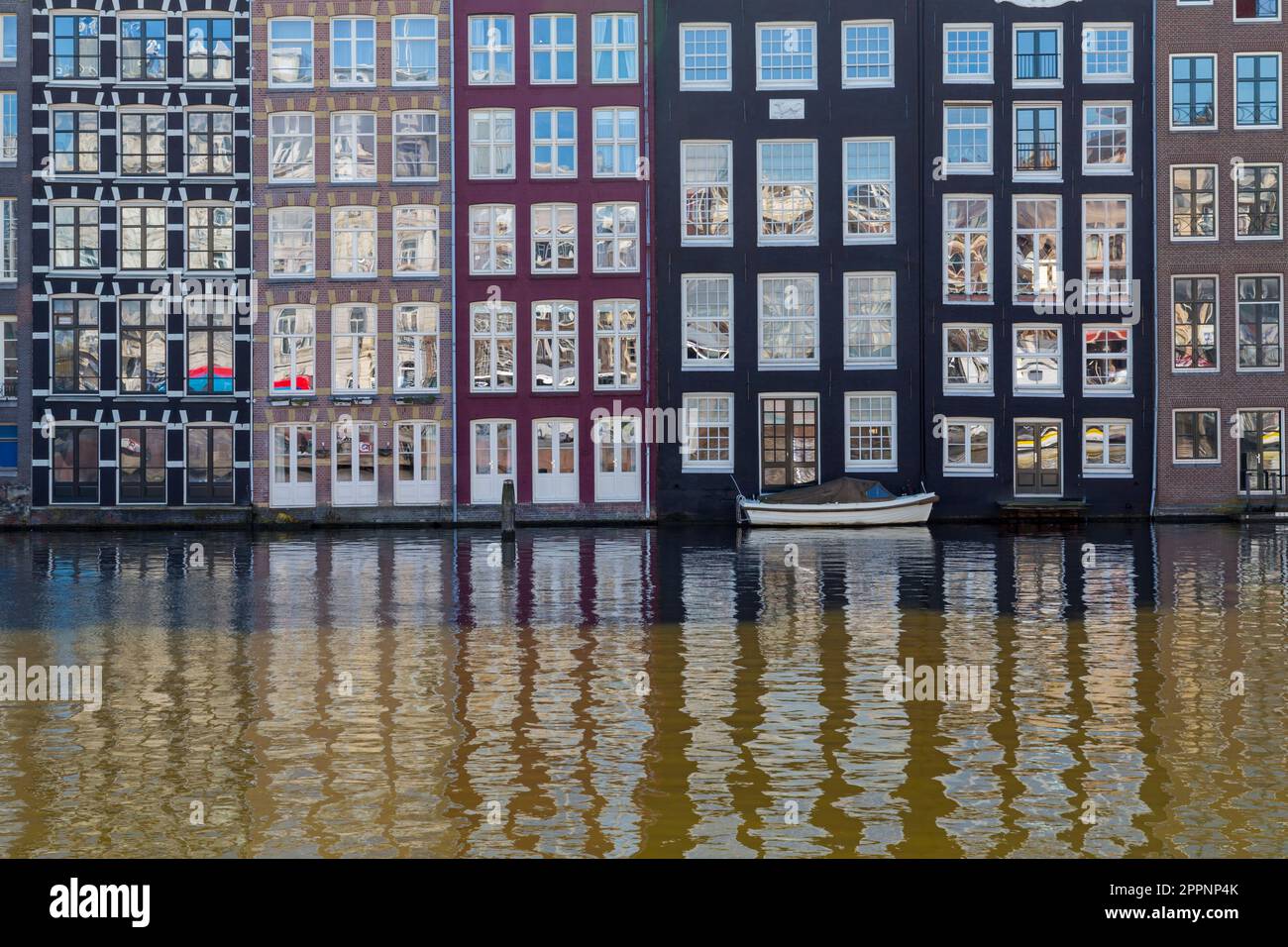 Dancing houses, buildings with reflections in windows by Damrak canal ...