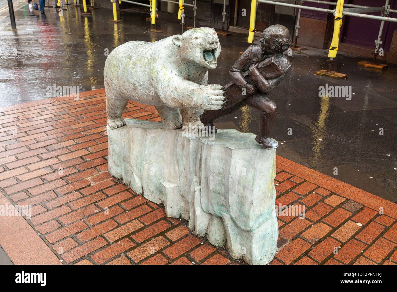 A bronze statue Dundee High Street by the artist David Annand, shows ...