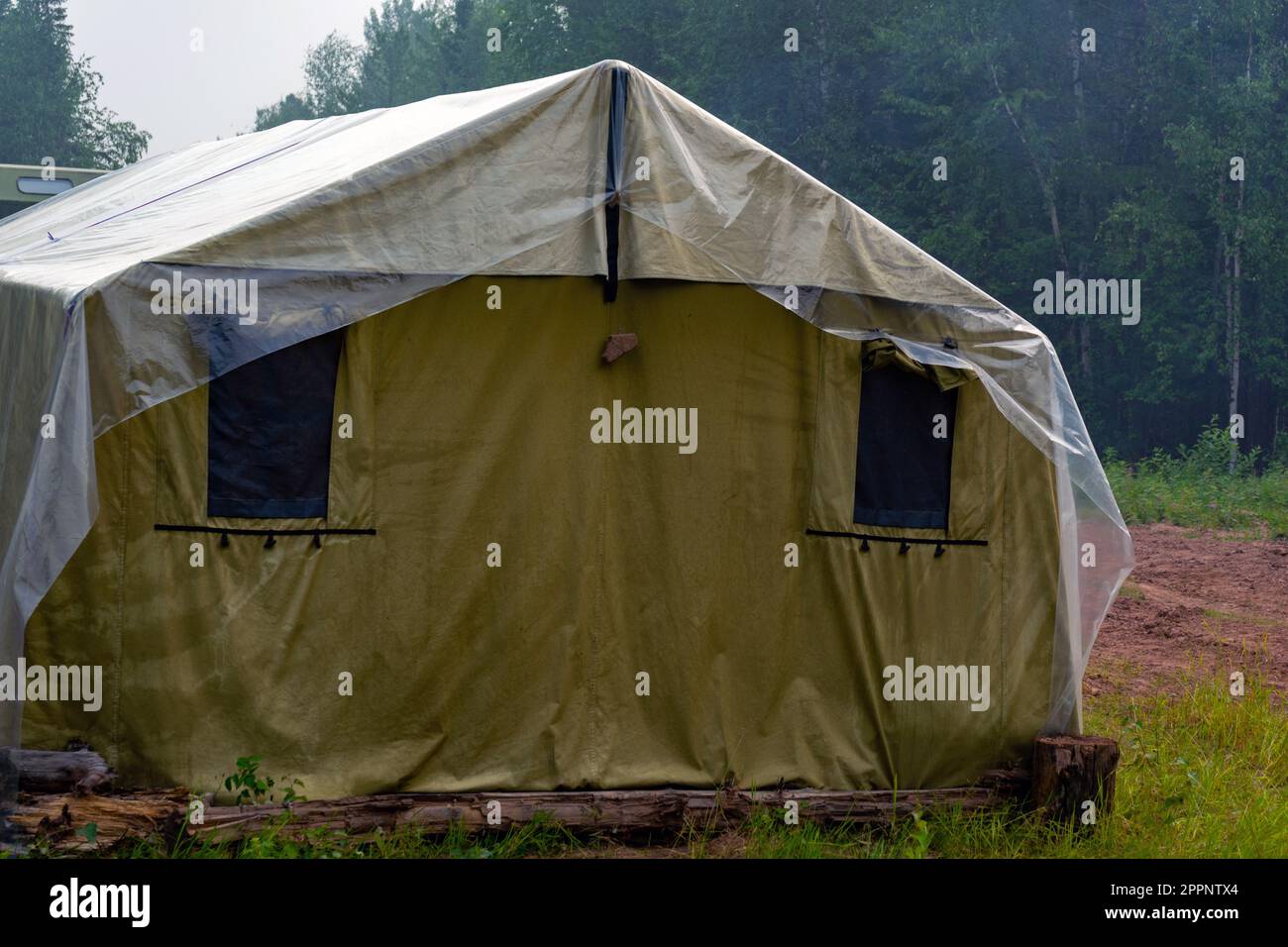 Military tent in the field. field camp in nature. large green tarpaulin ...