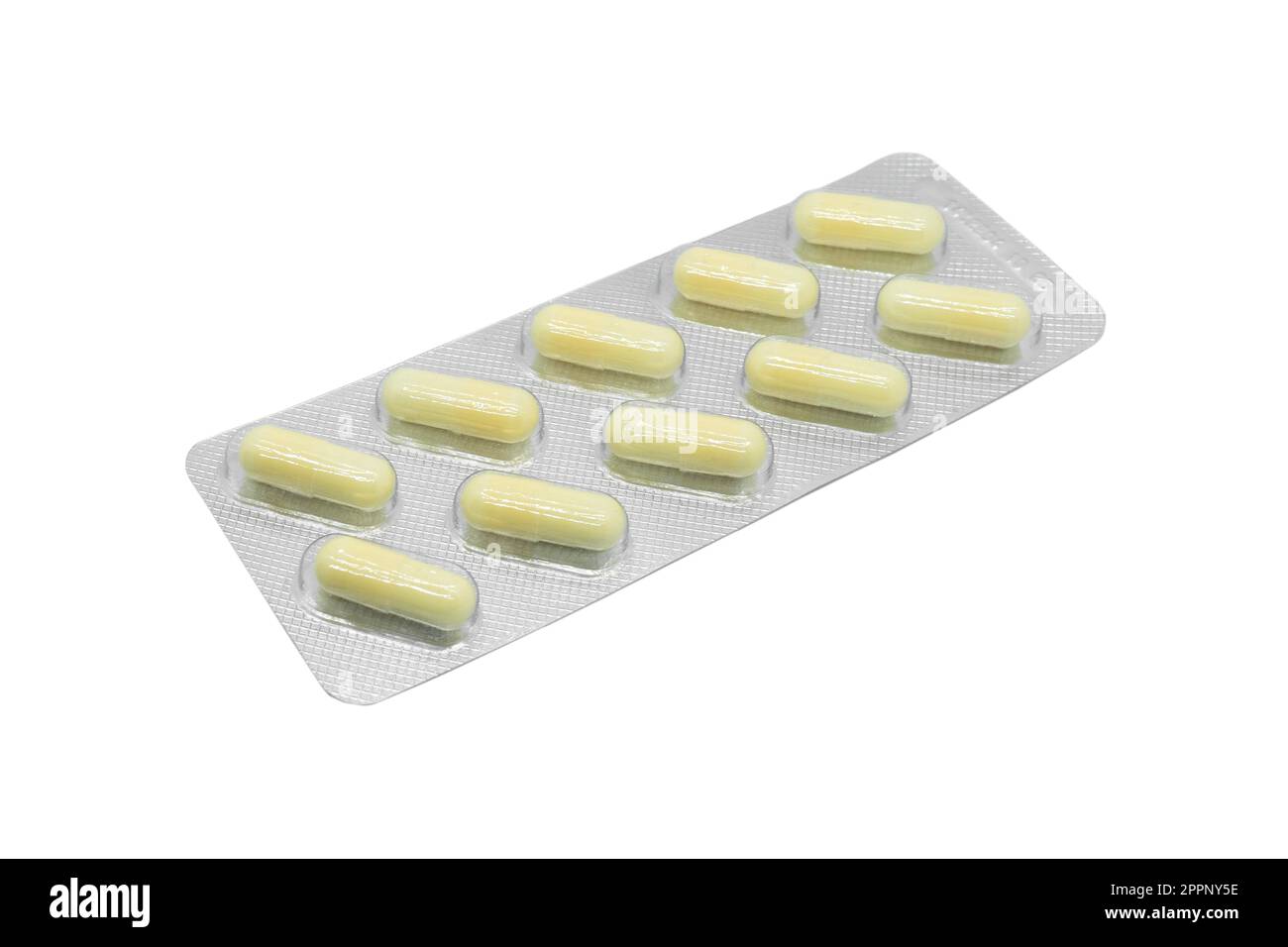 Macro shot pile of yellow tablets pill in silver blister packaging ...