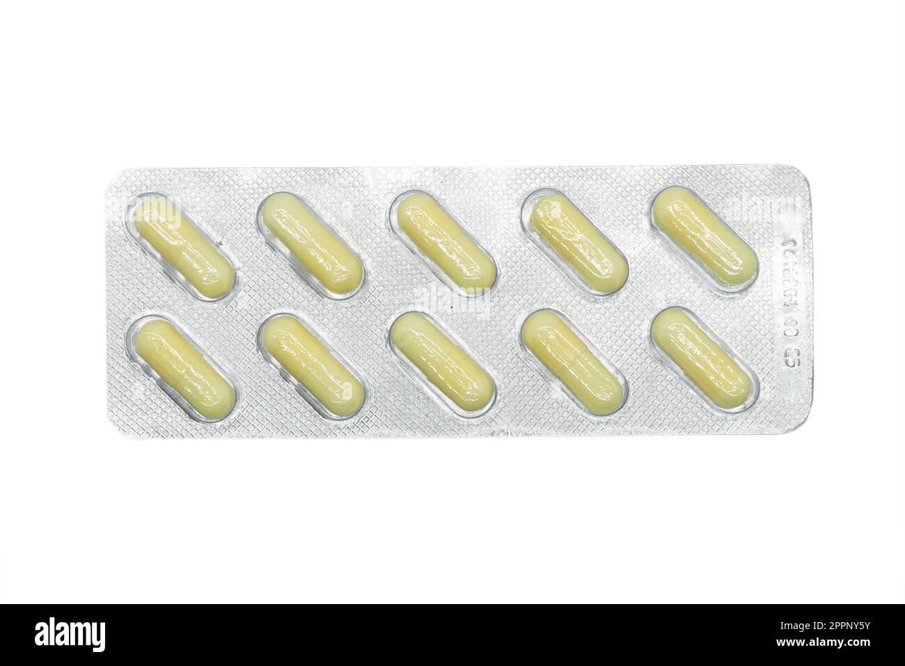 Macro shot pile of yellow tablets pill in silver blister packaging ...