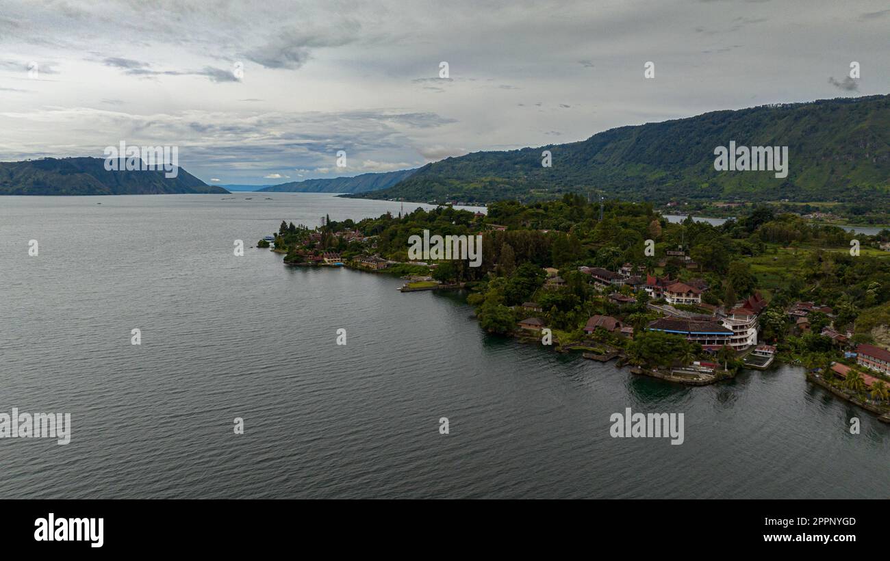 Aerial view of Tourist spot Tuk Tuk on Lake Toba and the coast of ...