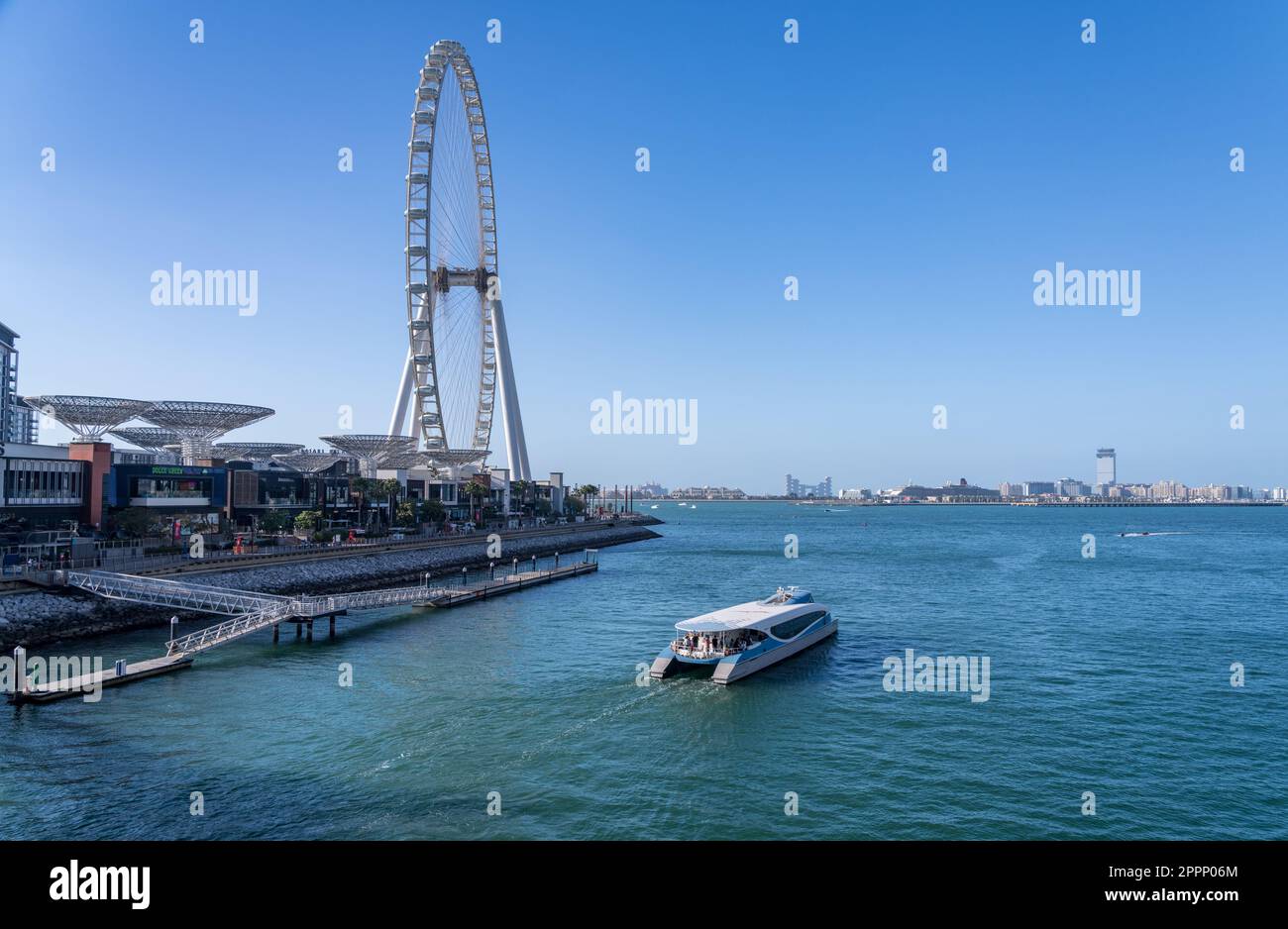 Dubai, UAE - April 3, 2023: Dubai Ferry departs past the Ain Dubai ...