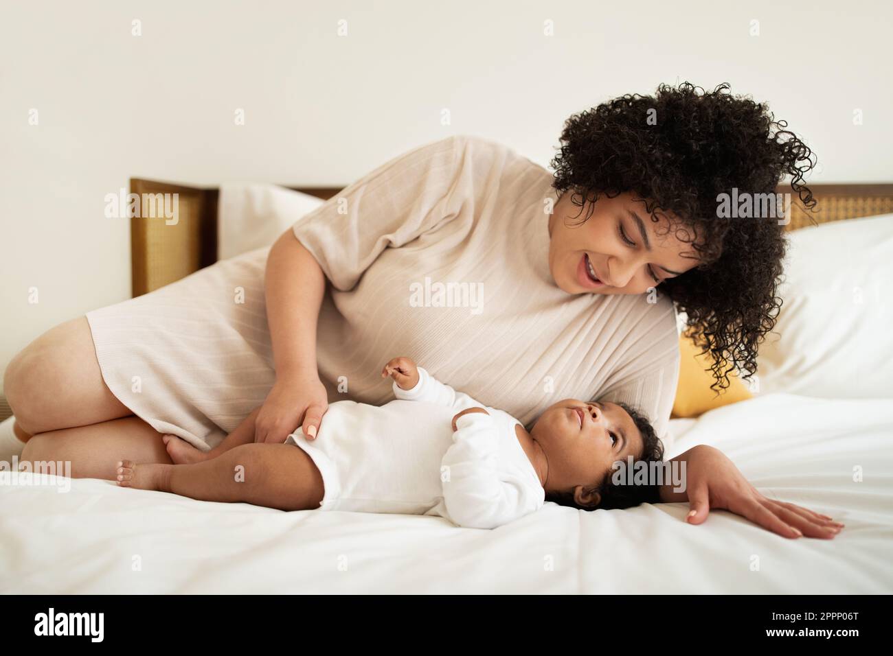 Positive young african american plus size woman and little kid lie on ...