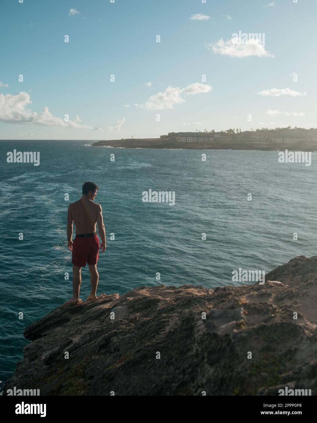 Man cliff diving and flipping at Waimea Bay on Oahu, Hawaii in the ...