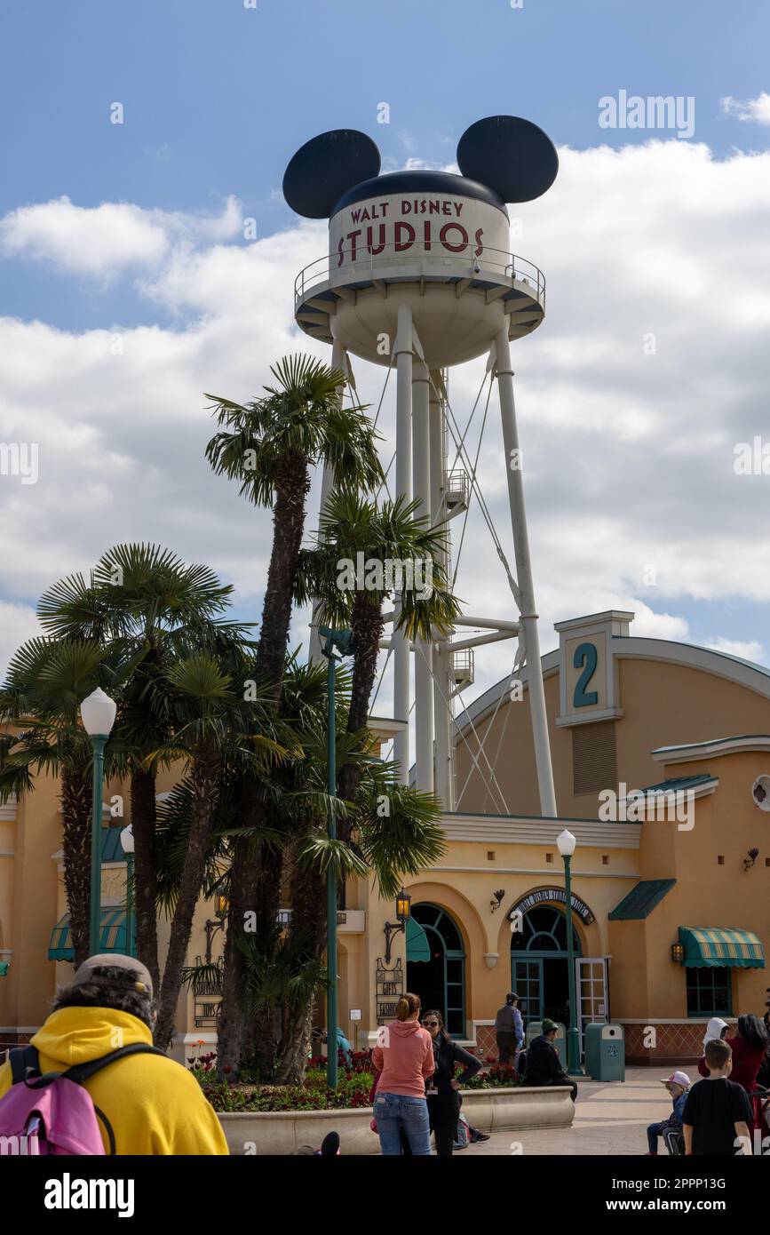 A group of people standing in front of the iconic Disney Studios Water ...