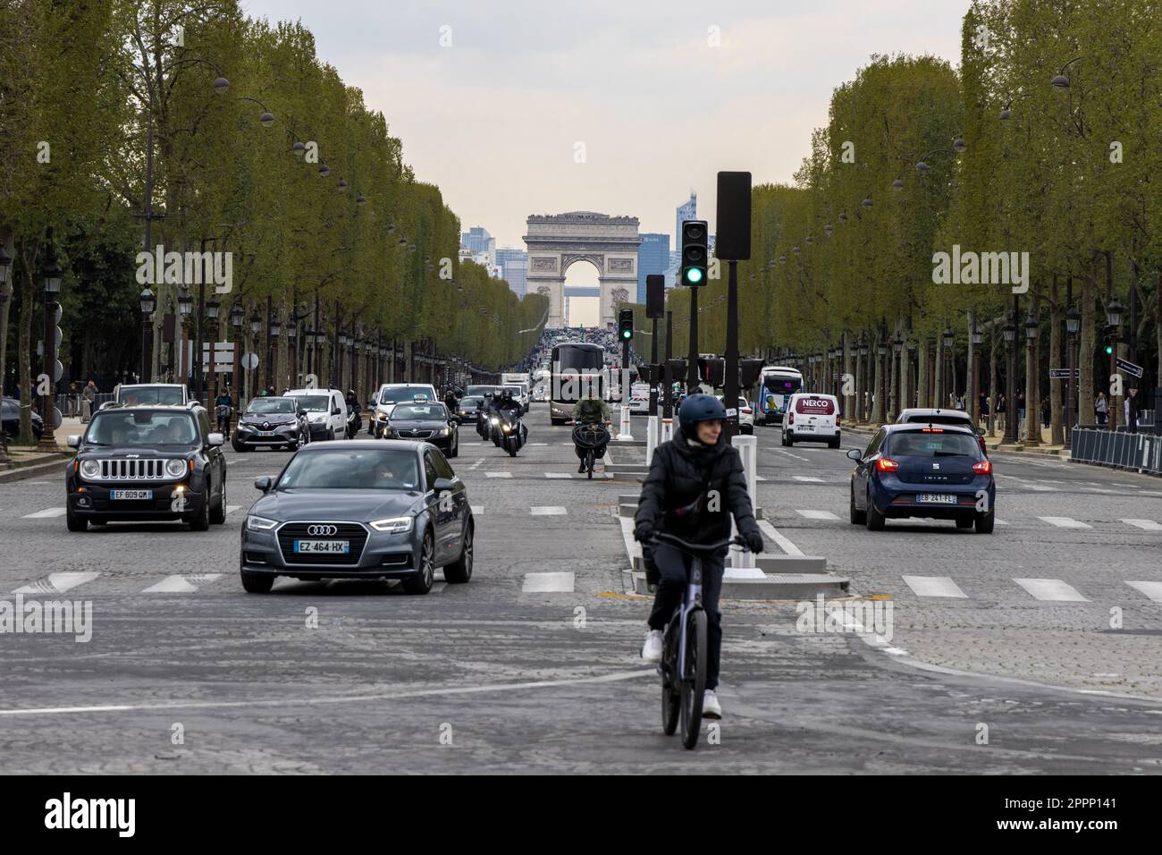 The traffic on Champs-Elysees Avenue with Arc de Triomphe in the ...