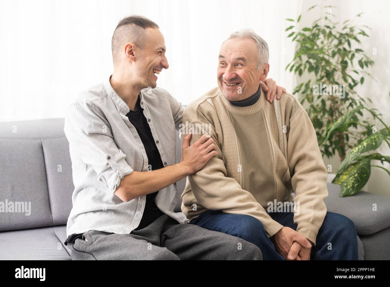 Young adult caucasian son listening and supporting his old elderly ...