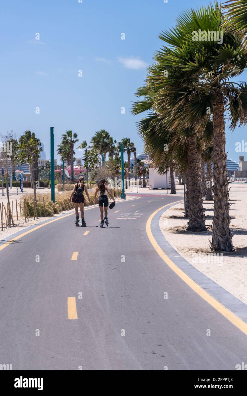Two women roller blading along cycle track at Jumeirah Wild public ...