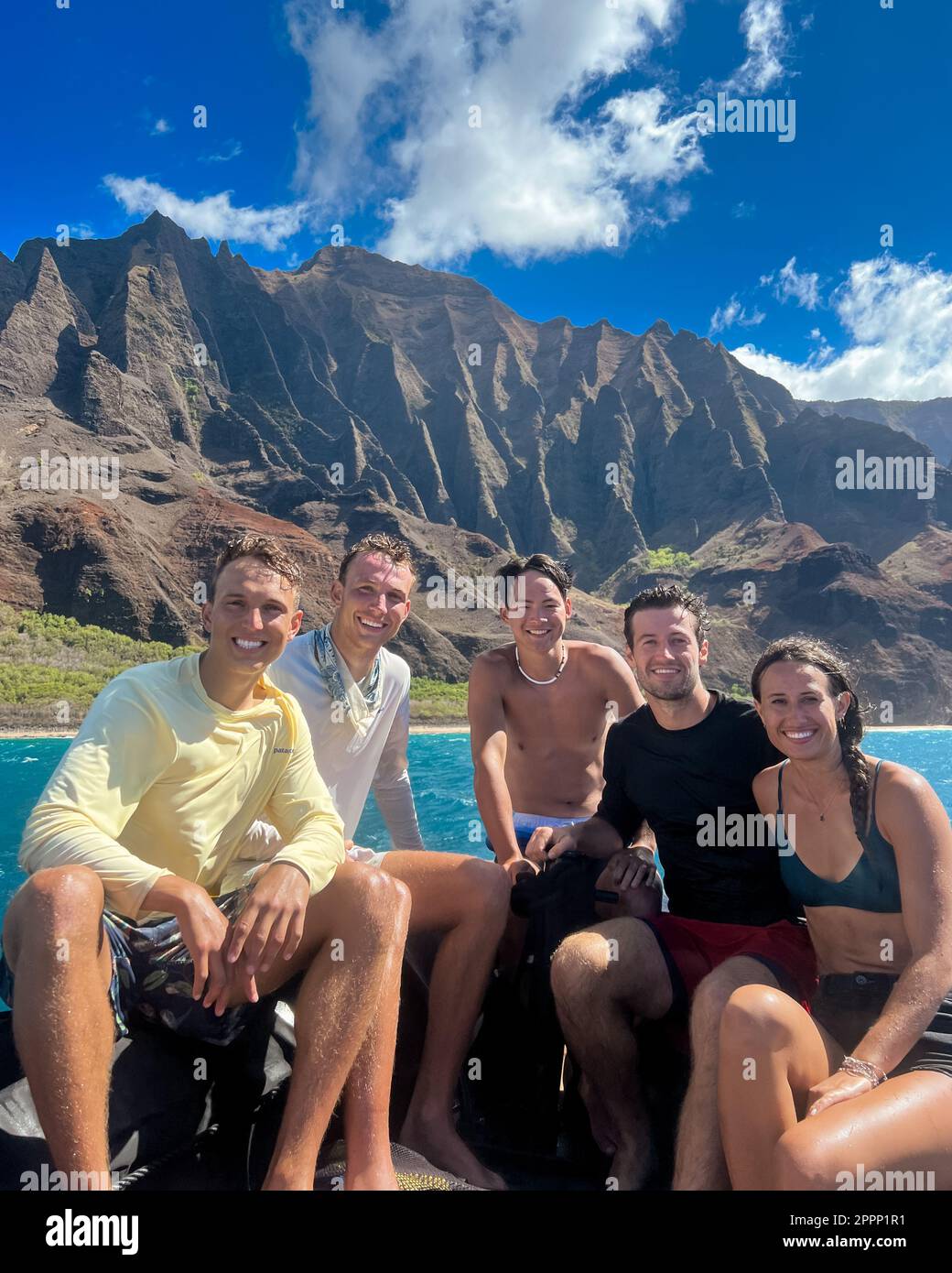Group of friends on a boat tour off of Na Pali Coast State Park in ...