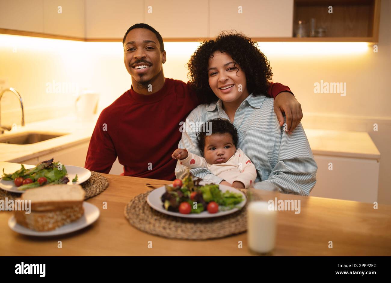 Happy multicultural family with little baby daughter at kitchen Stock ...