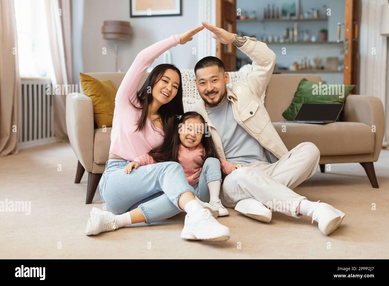 Happy Japanese Parents Joining Hands Making Roof Above Daughter Indoor Stock Photo - Alamy