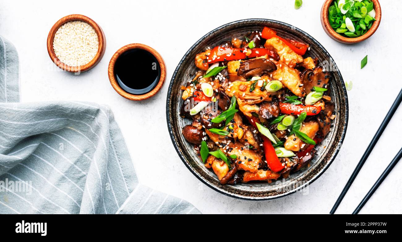 Stir fry chicken fillet, red paprika, mushrooms, green chives and ...