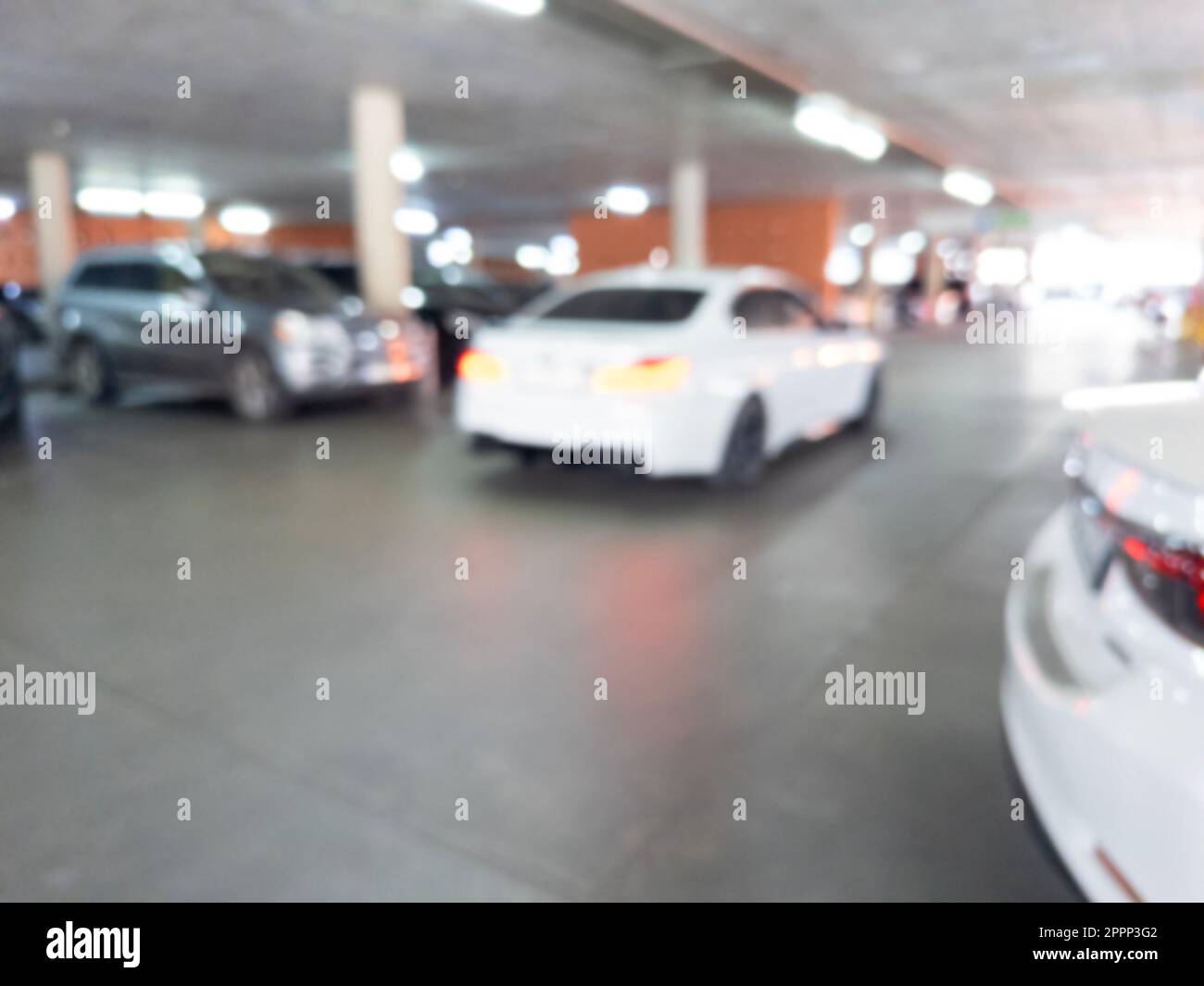 Blurred cars in car parking lot in shopping mall. Bokeh lights ...