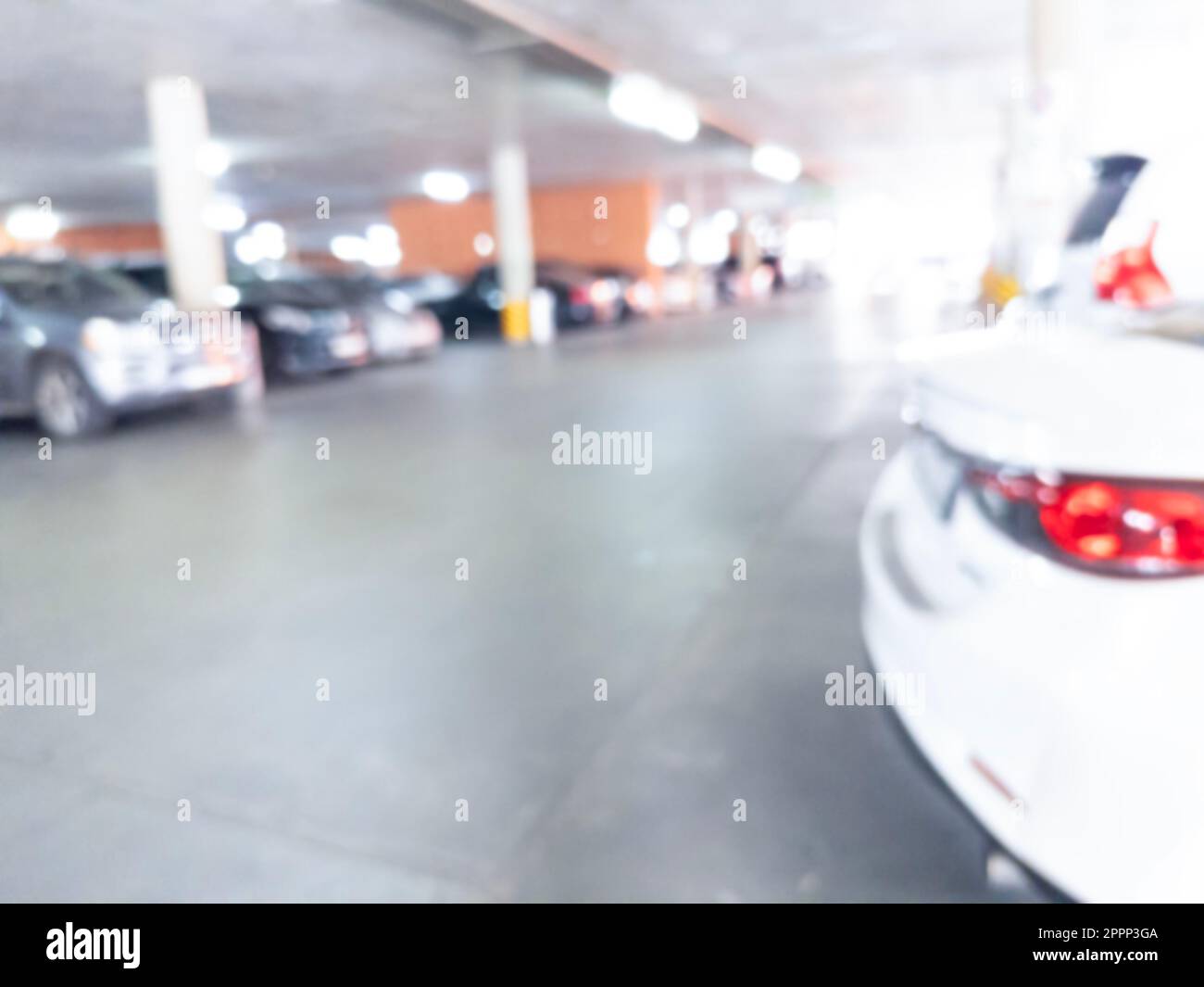Blurred cars in car parking lot in shopping mall. Bokeh lights ...