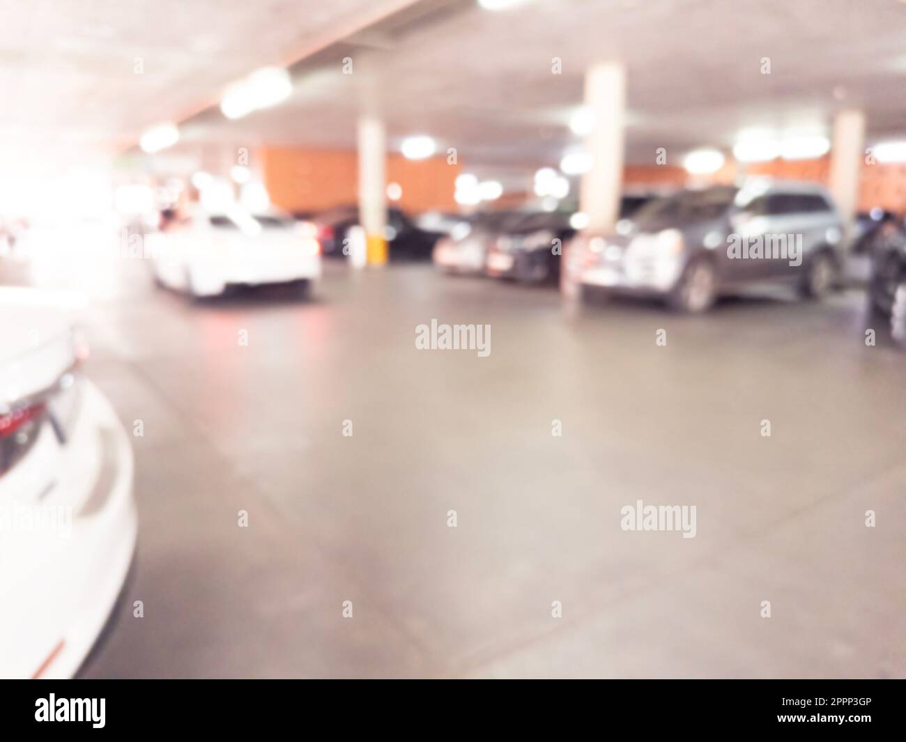 Blurred cars in car parking lot in shopping mall. Bokeh lights ...
