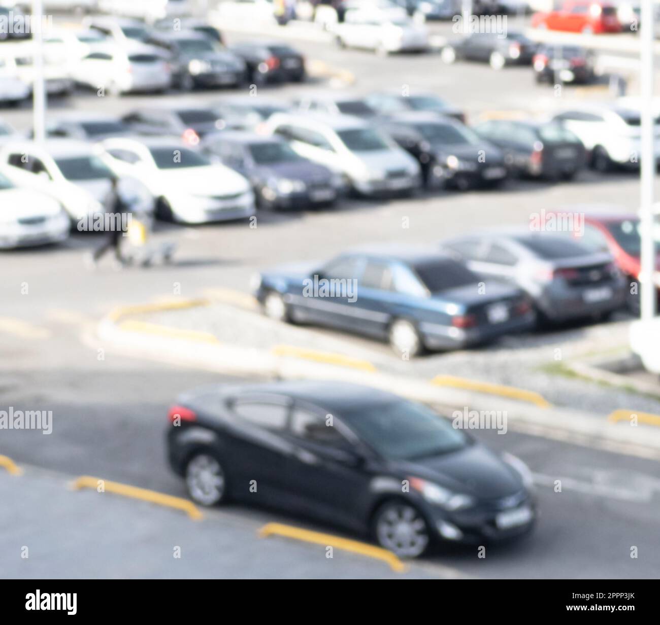 Aerial view blurred cars in car parking lot in shopping mall. Bokeh ...