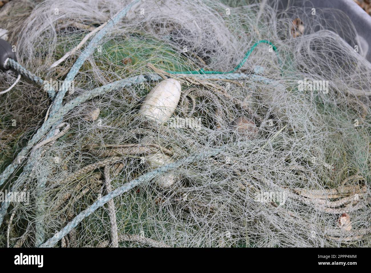 Fishing nets and floats lying on ground for use as background Stock ...