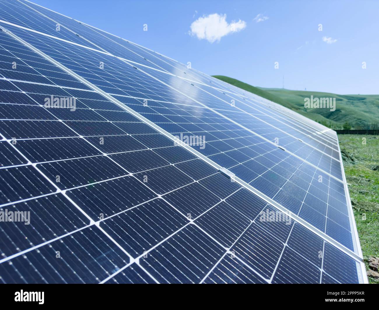 Blue Solar panel over blue sky, mountains, sun and clouds. Solar panels ...