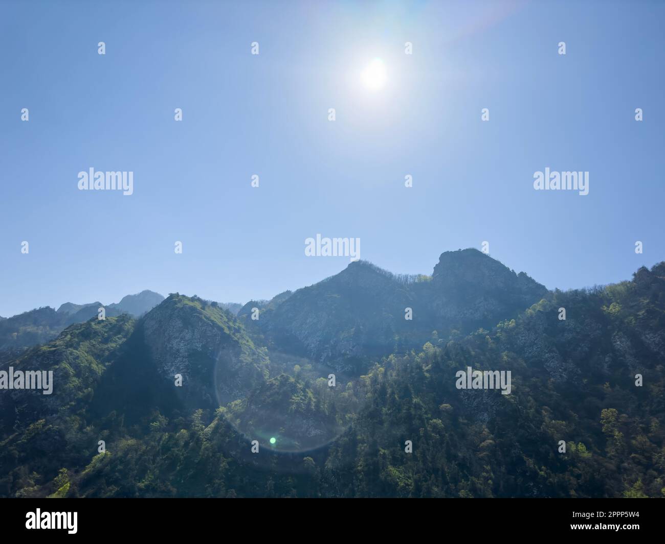 Scenic aerial mountain view to green forest valley in sunlight among ...