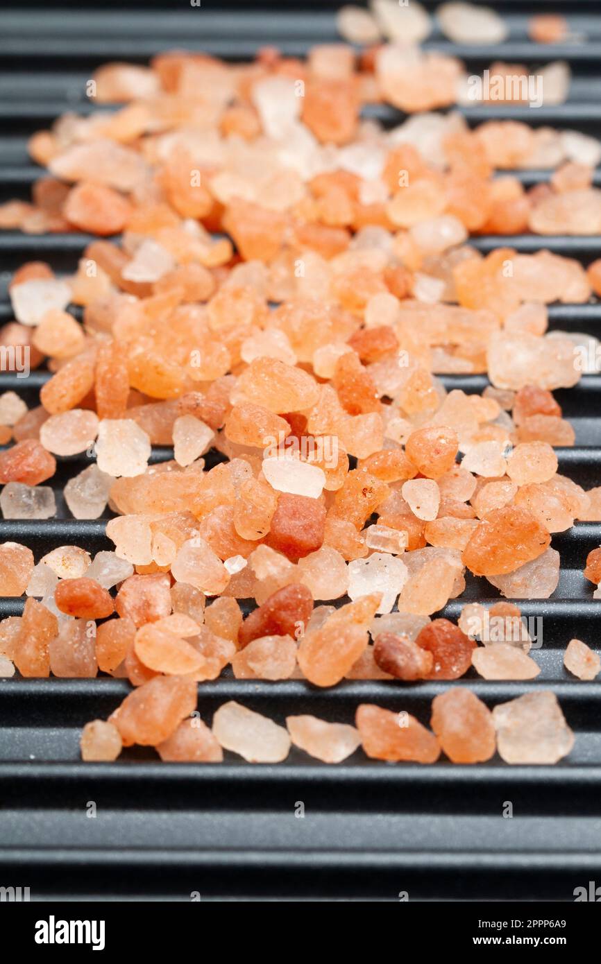 heap of Himalayan salt grains, on the black pan Stock Photo - Alamy