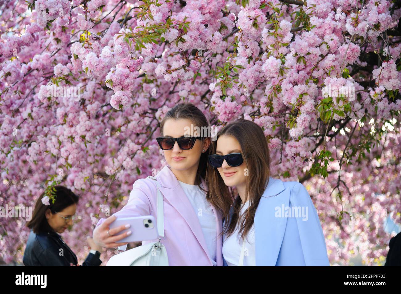 Lviv, Ukraine. 24th Apr, 2023. Two young ladies make poses as they take ...