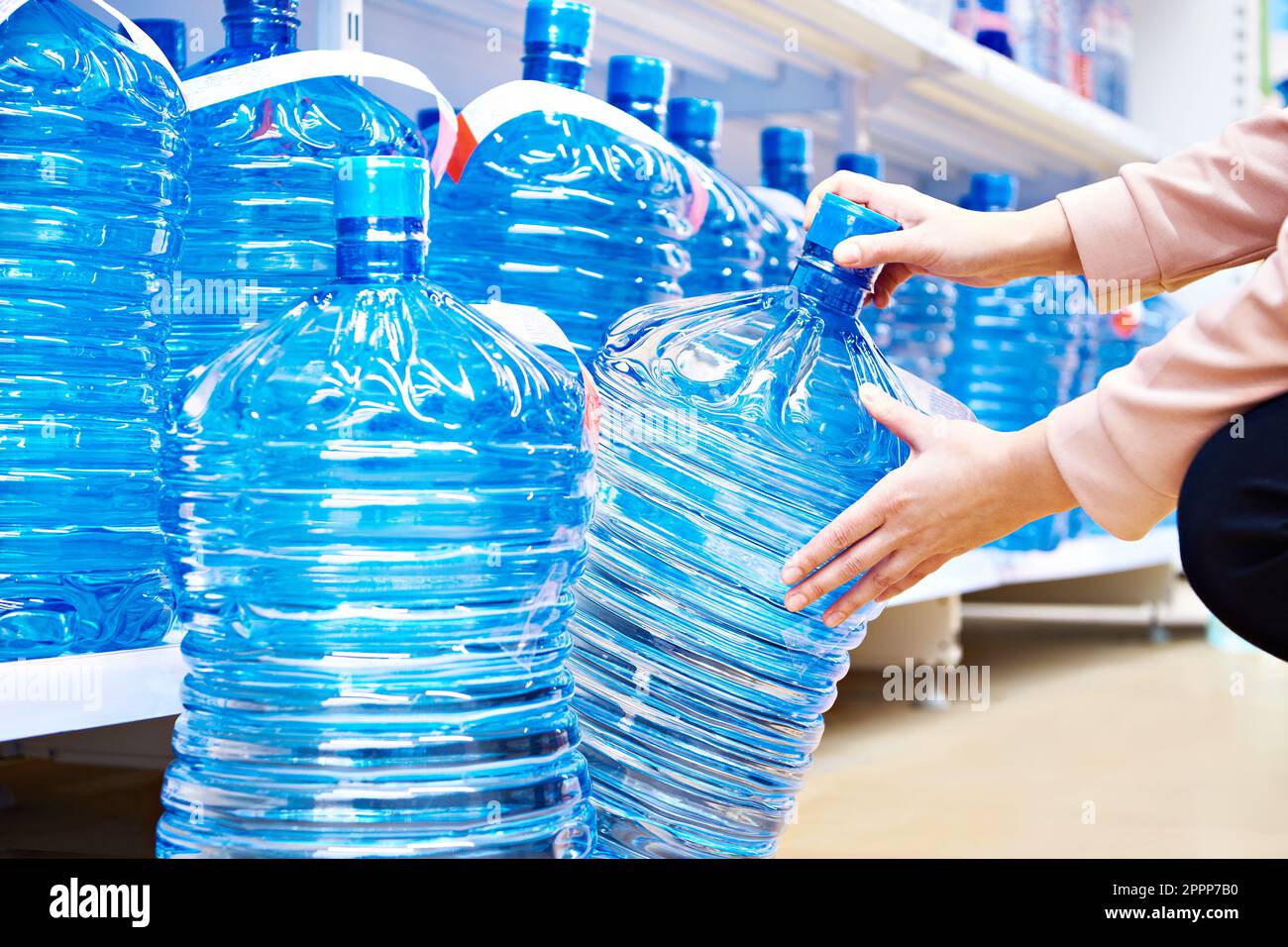 Bottles of drinking water for dispenser in store Stock Photo - Alamy