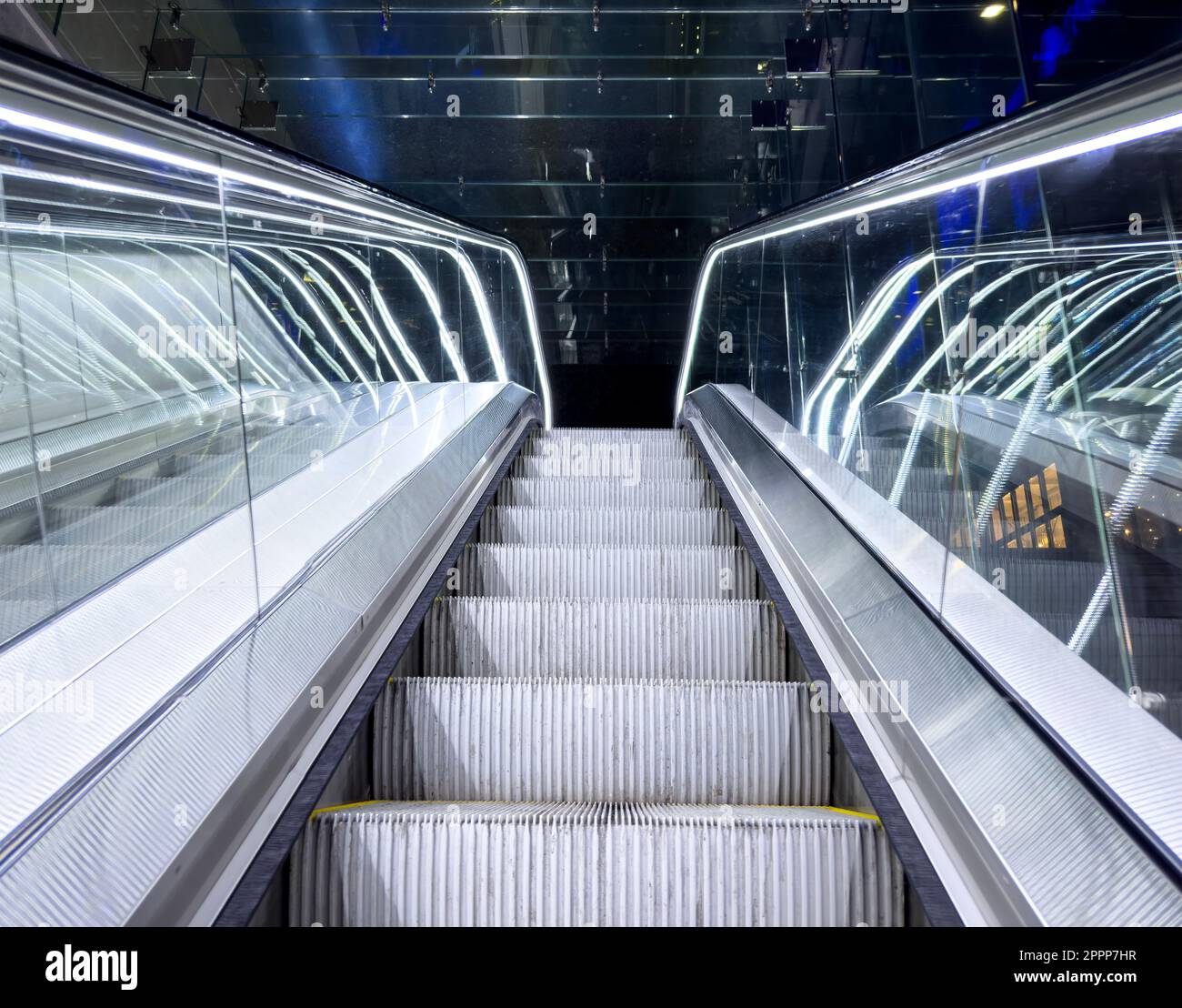 Escalators. Electric stairs in a public area. Modern automatic escalator system in shopping mall ...