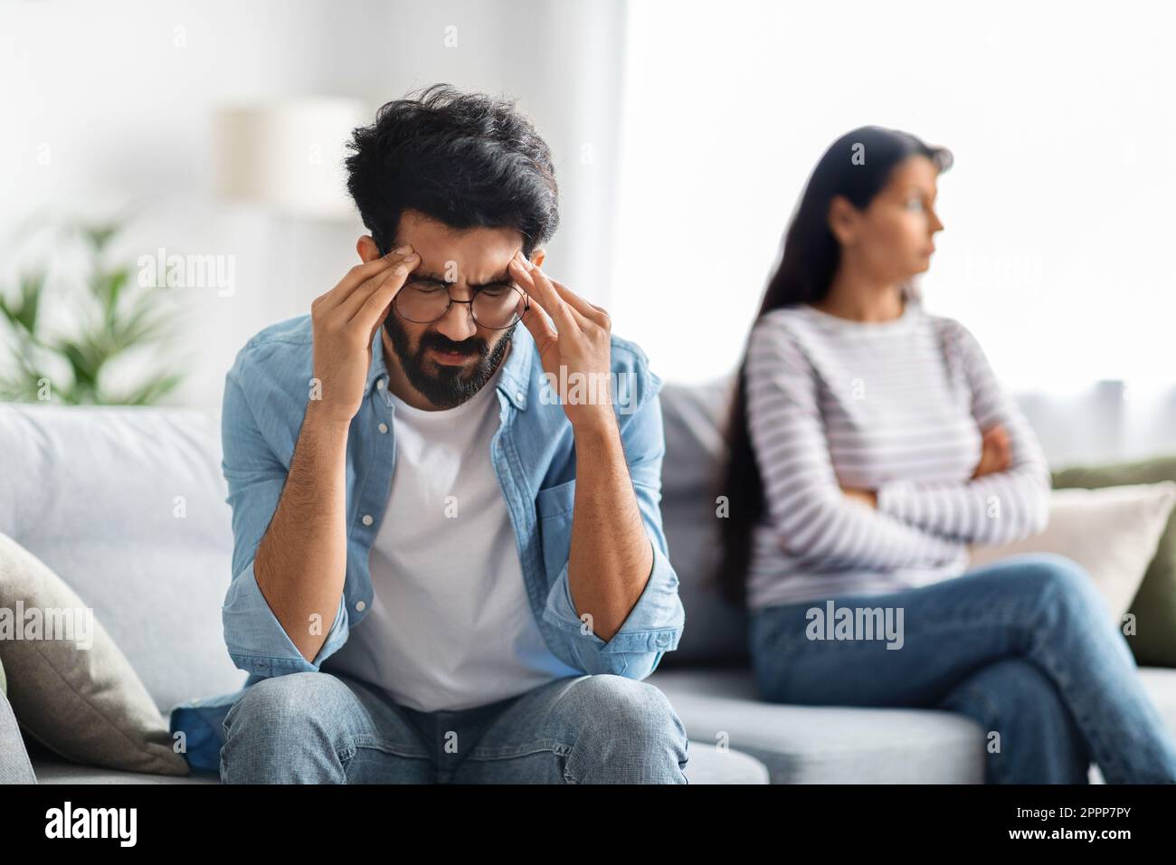 Frustrated indian man touching his head, fighting with wife Stock Photo ...