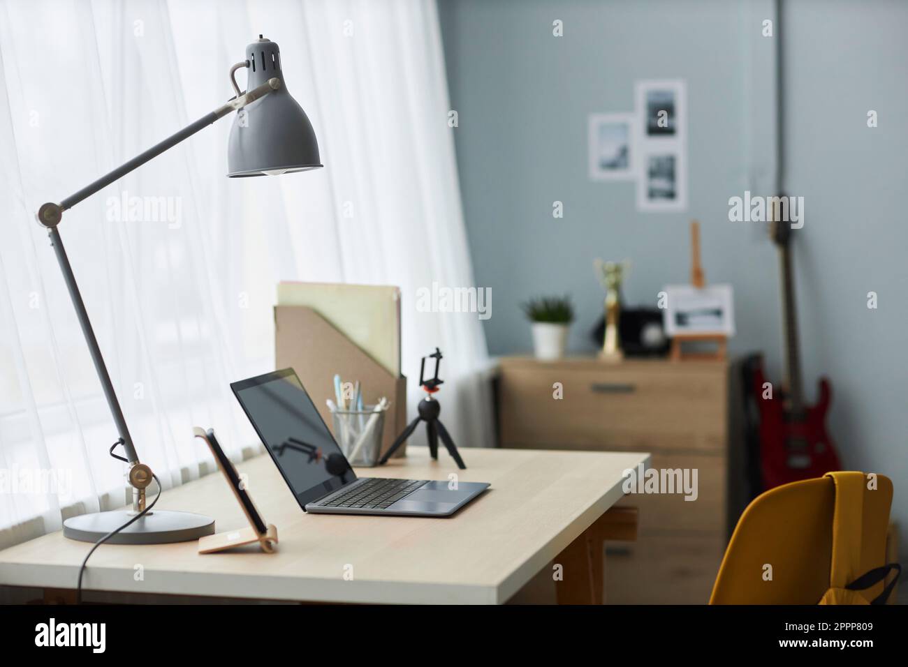 Lamp on desk with laptop which is workplace of student, designer or ...