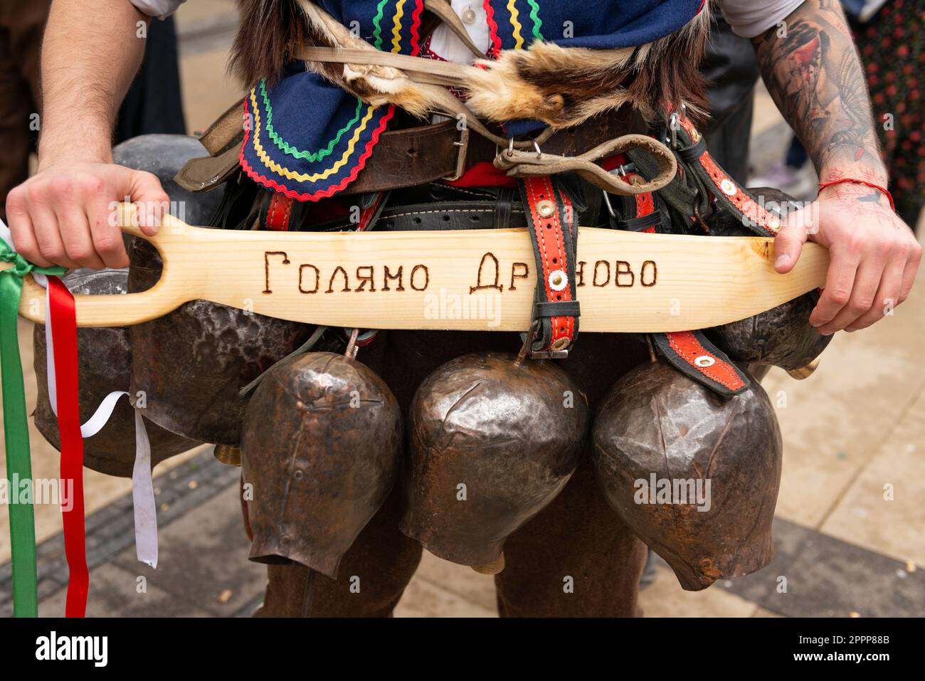 Kukeri dancer with large bells and wooden sword outfit and gear details ...