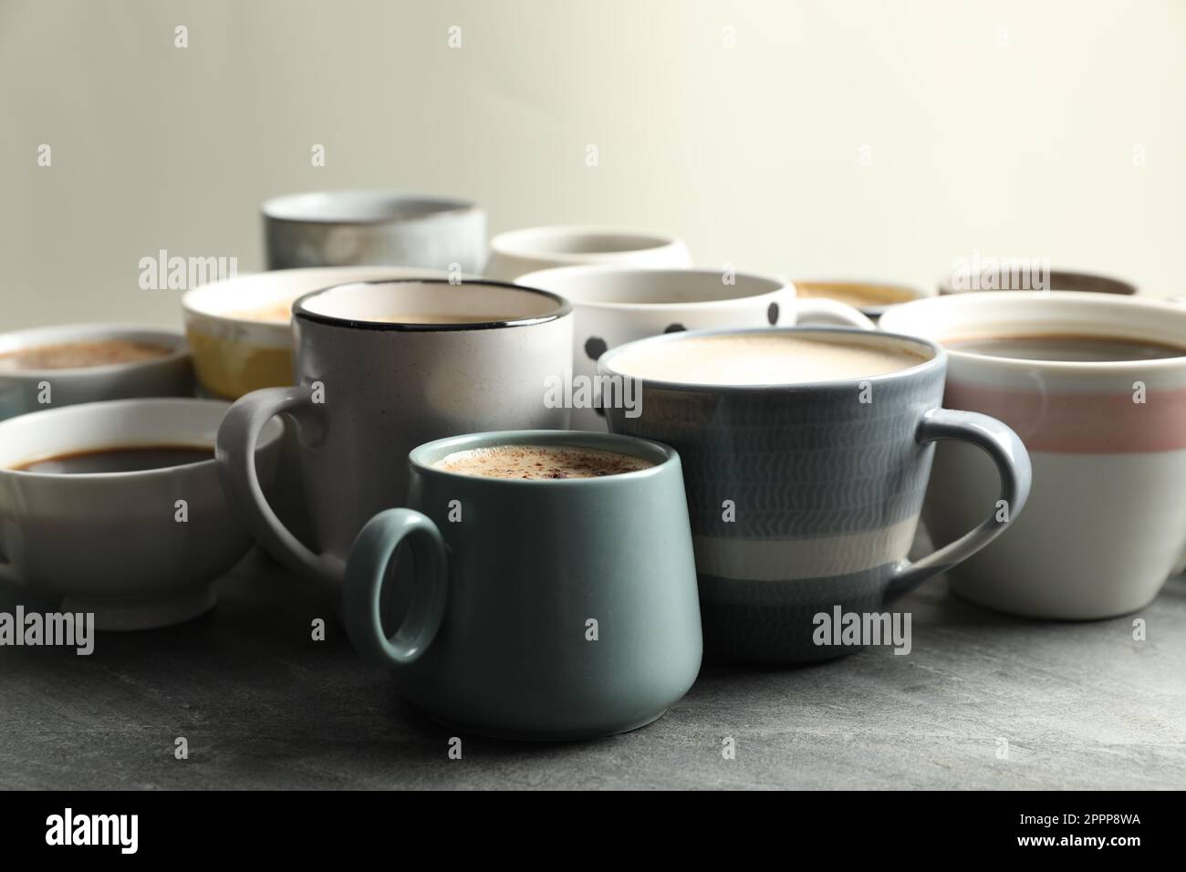 Many cups of different coffees on slate table Stock Photo - Alamy