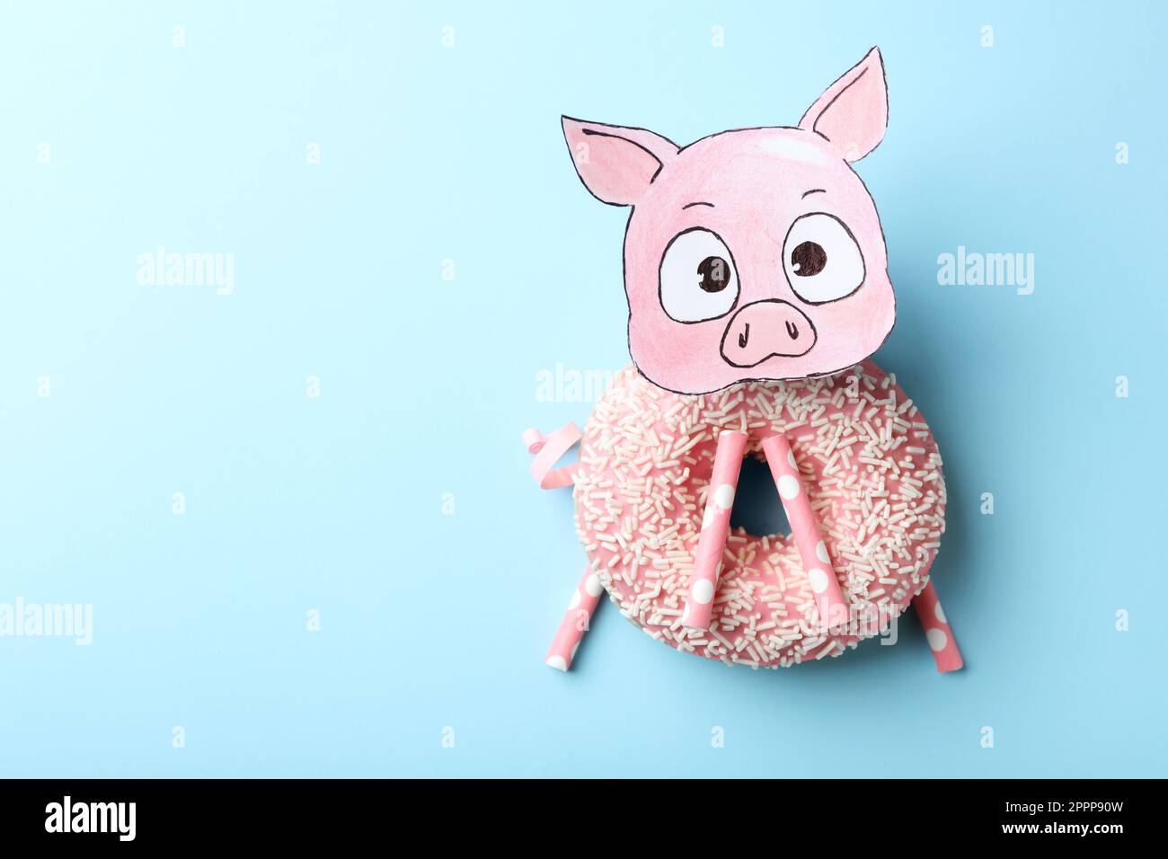Funny pig made with donut and straws on light blue background, flat lay ...