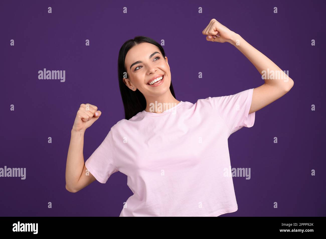 Strong woman as symbol of girl power on purple background. 8 March ...