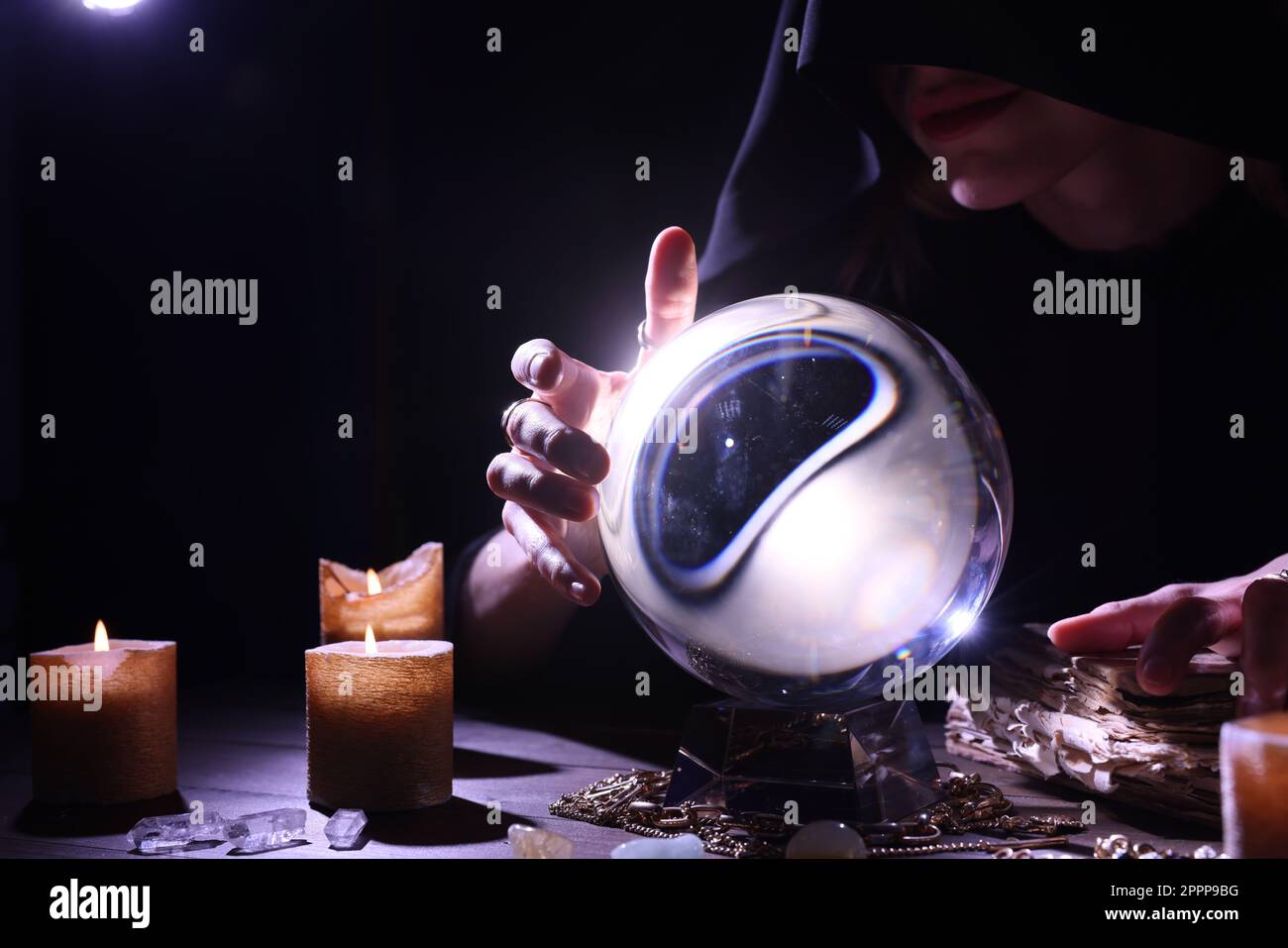 Soothsayer Using Crystal Ball To Predict Future At Table In Darkness