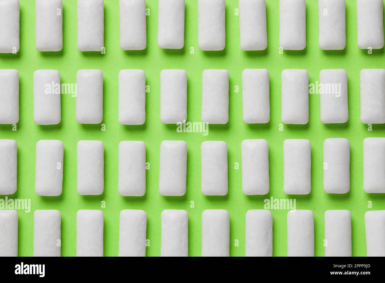 Many chewing gum pieces on green background, flat lay Stock Photo - Alamy