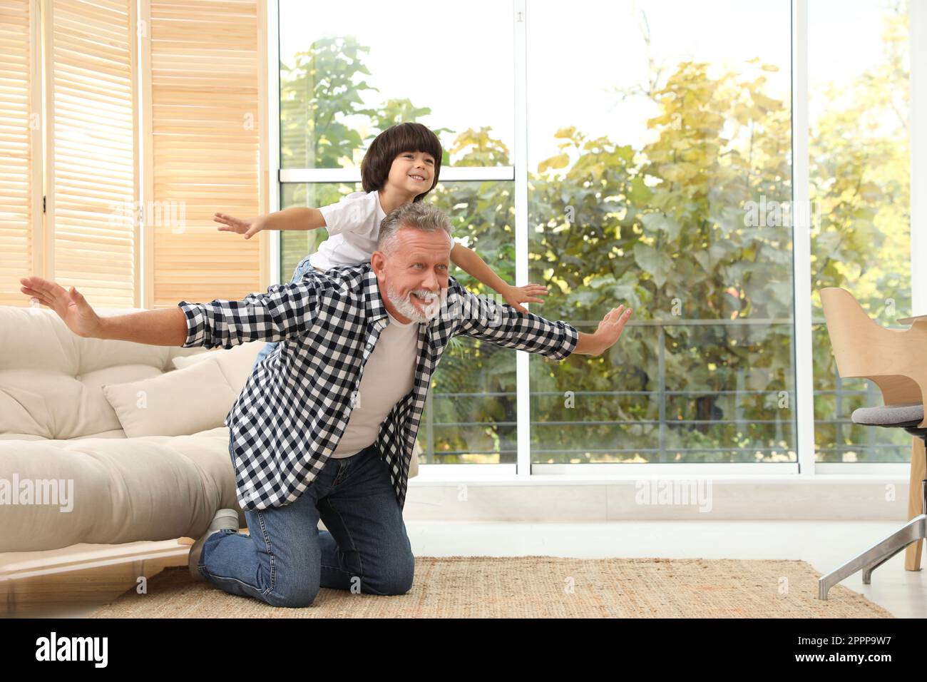 Happy grandfather with his grandson playing together at home Stock ...