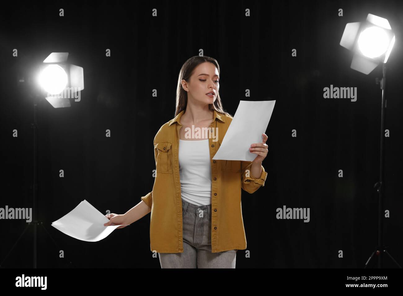 Professional actress reading her script during rehearsal in theatre ...