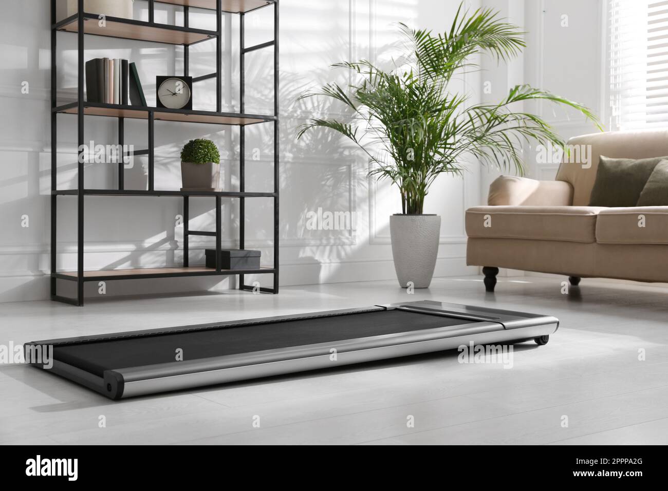 Modern walking treadmill in living room. Home gym equipment Stock Photo ...