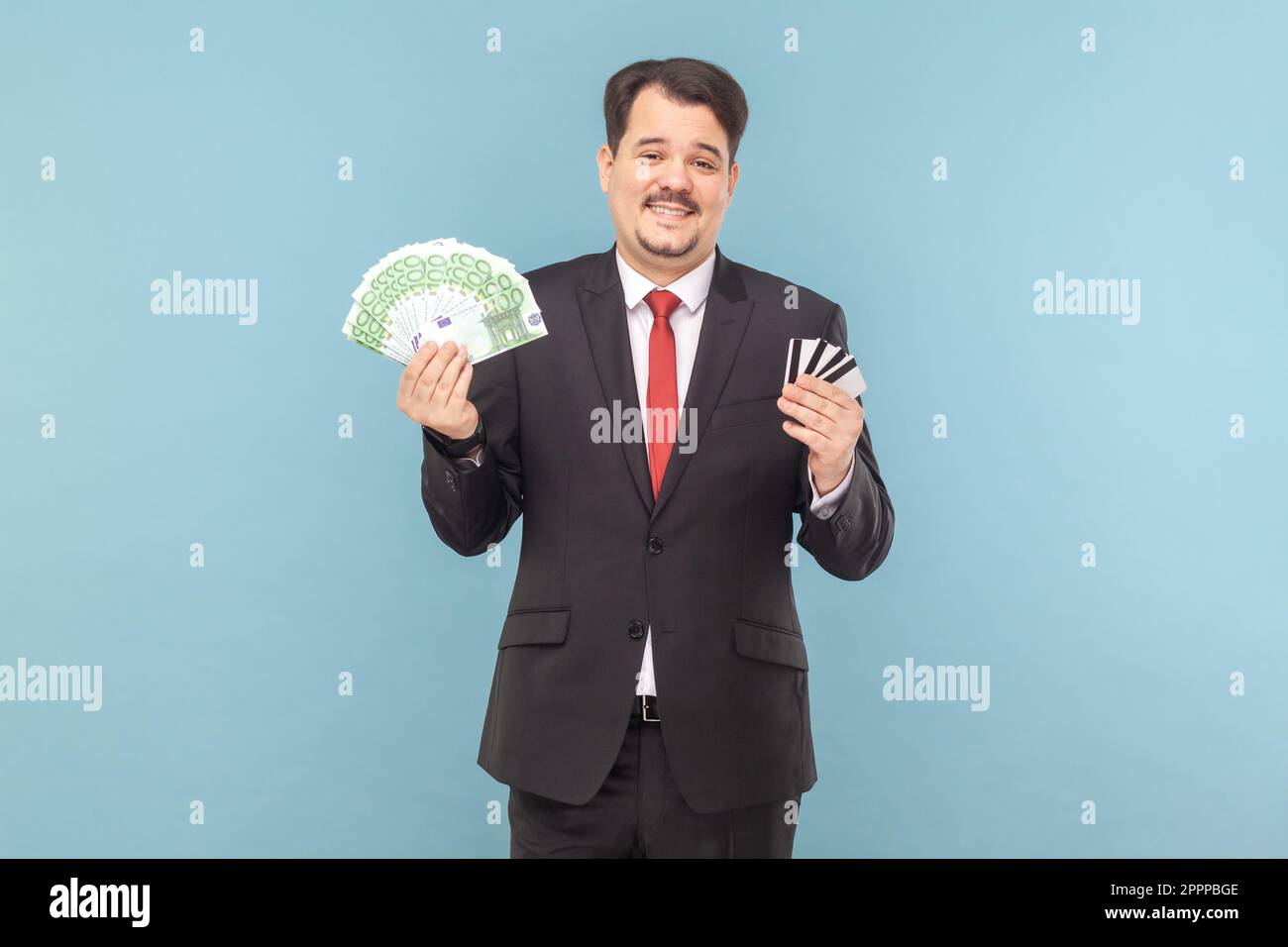 Satisfied rich man with mustache standing holding euro banknotes and ...
