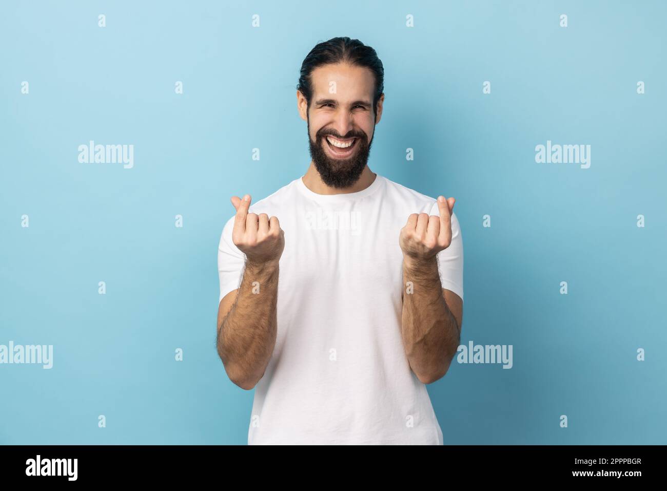 Portrait of smiling happy positive man with beard wearing white T-shirt ...